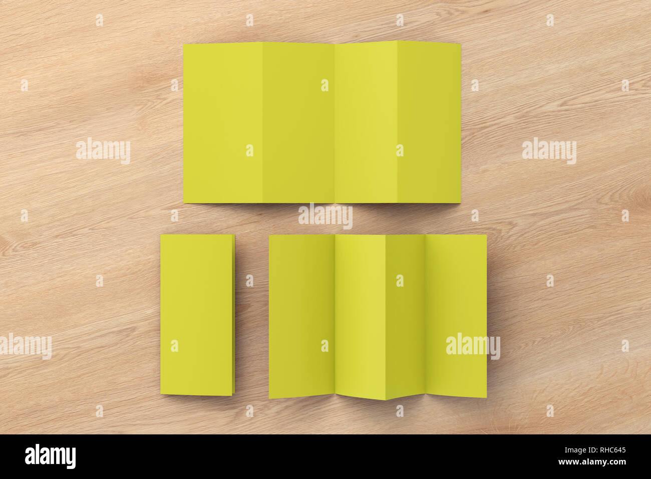 Blank yellow folded paper leaflet on wooden background. Eight pages ...
