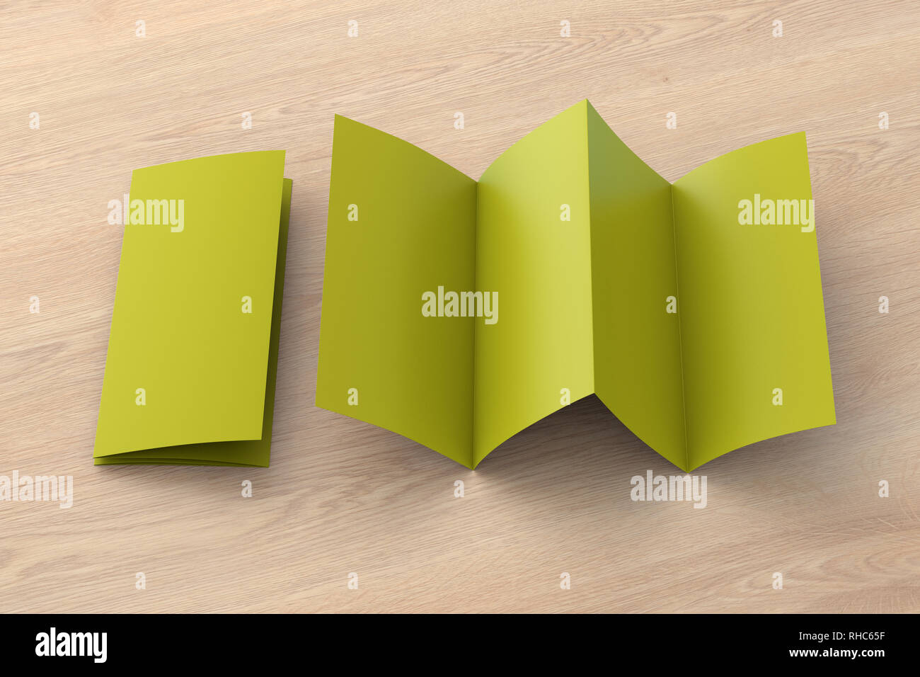 Blank yellow folded paper leaflet on wooden background. Eight pages ...