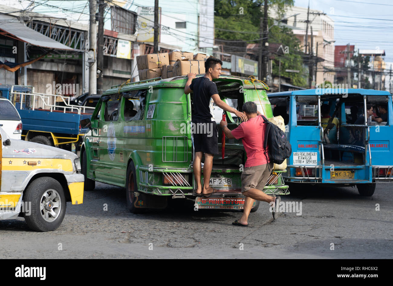 A typical scene within the Philippines whereby the Jeepney conductor ...