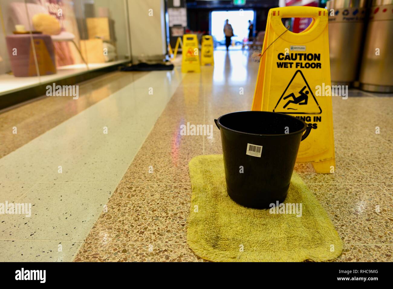 Caution wet floor sign and a bucket, Inside stockland shopping centre ...