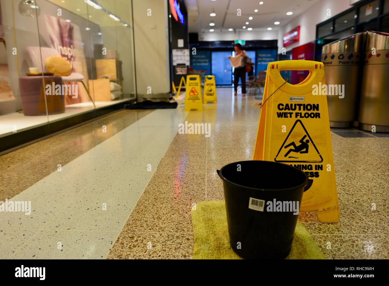 Caution wet floor sign and a bucket, Inside stockland shopping centre ...