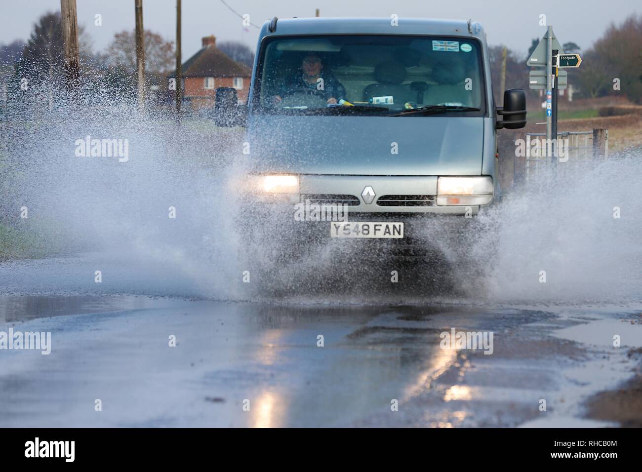 Van driving through flooded road making a splash, ashford, kent, uk ...