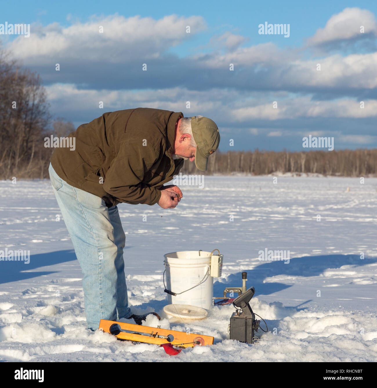 Ice fisherman preparing his bait Stock Photo - Alamy