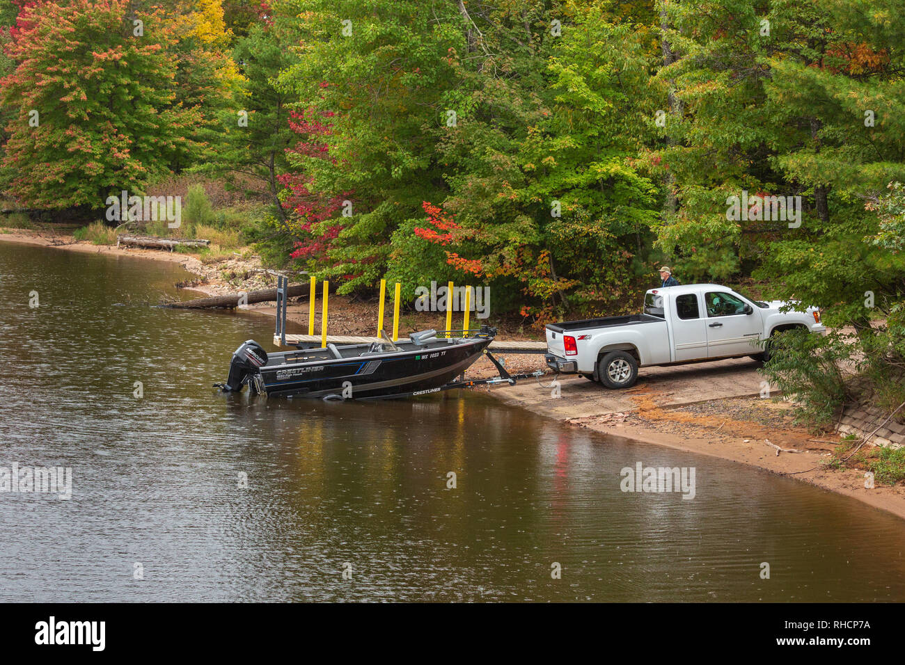 A man pulling his boat out of the Rainbow Flowage after a successful ...