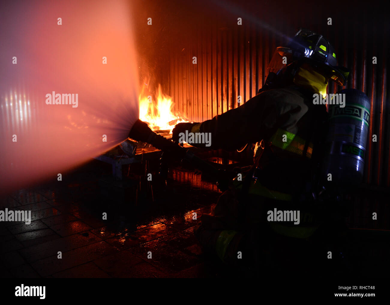 A Soldier with the South Dakota National Guard puts out a fire during a ...