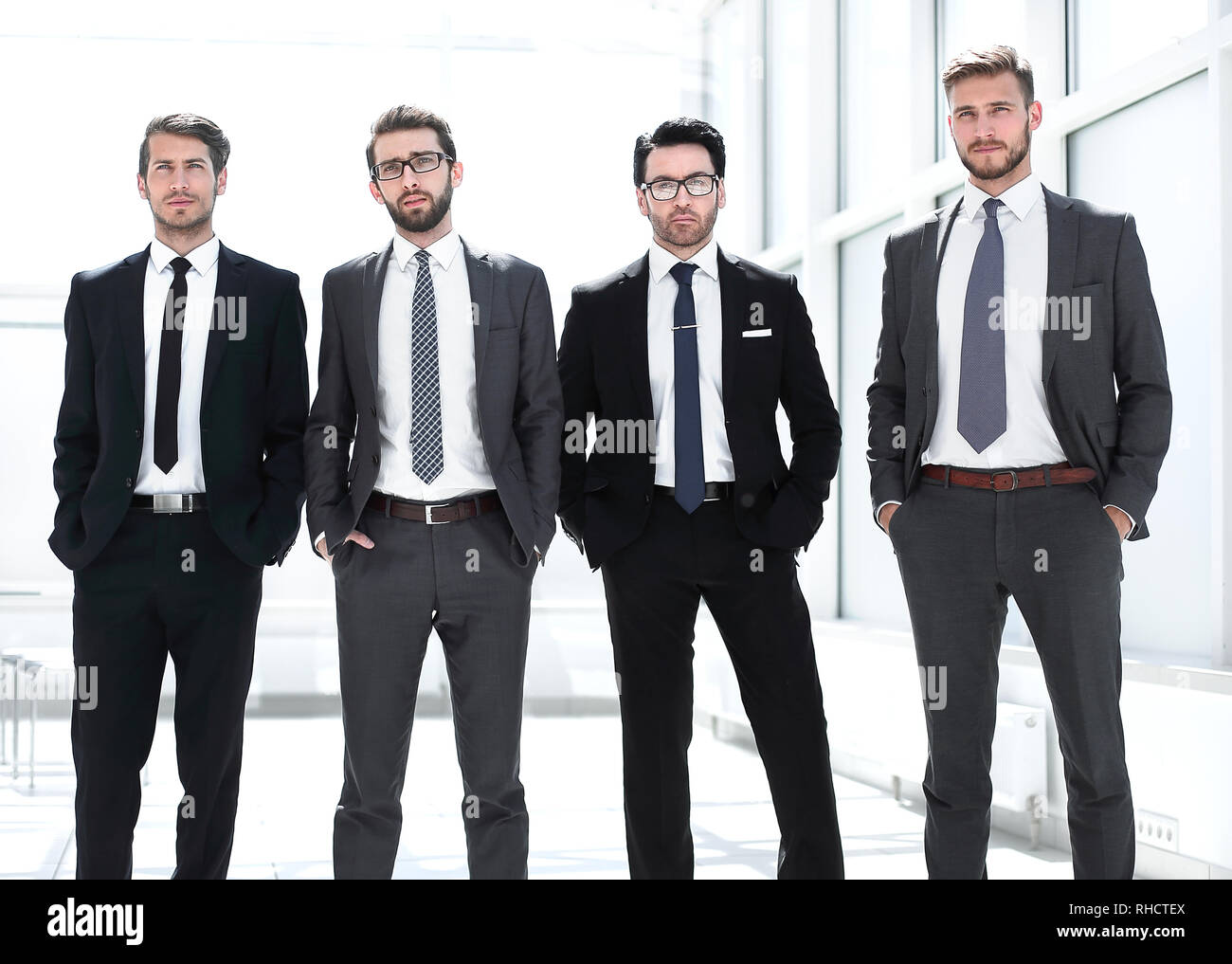 four businessmen standing together Stock Photo - Alamy