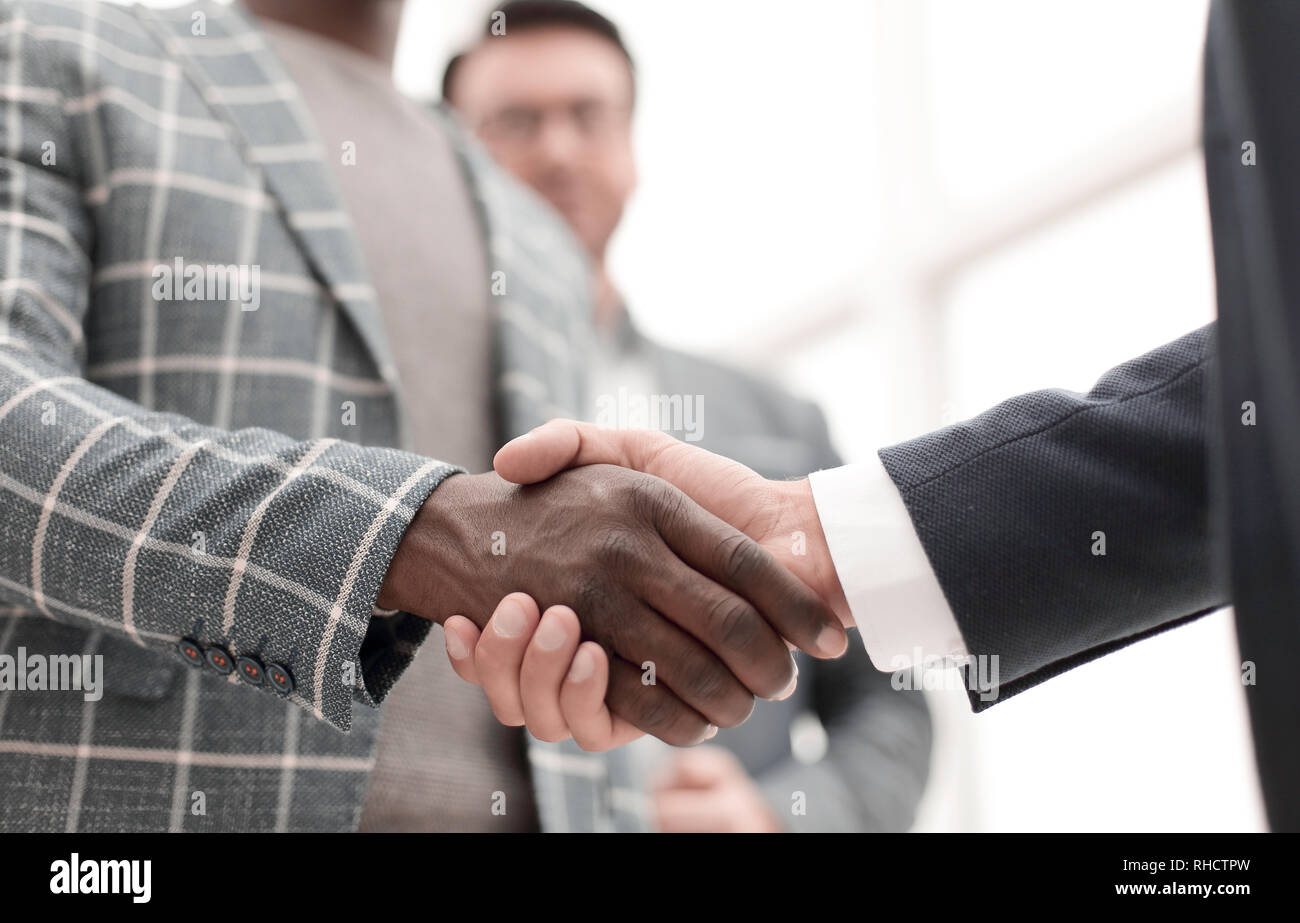 close up.handshake entrepreneurs on the background of the office Stock ...