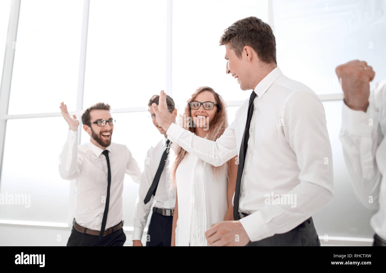 happy employees standing in spacious office Stock Photo - Alamy