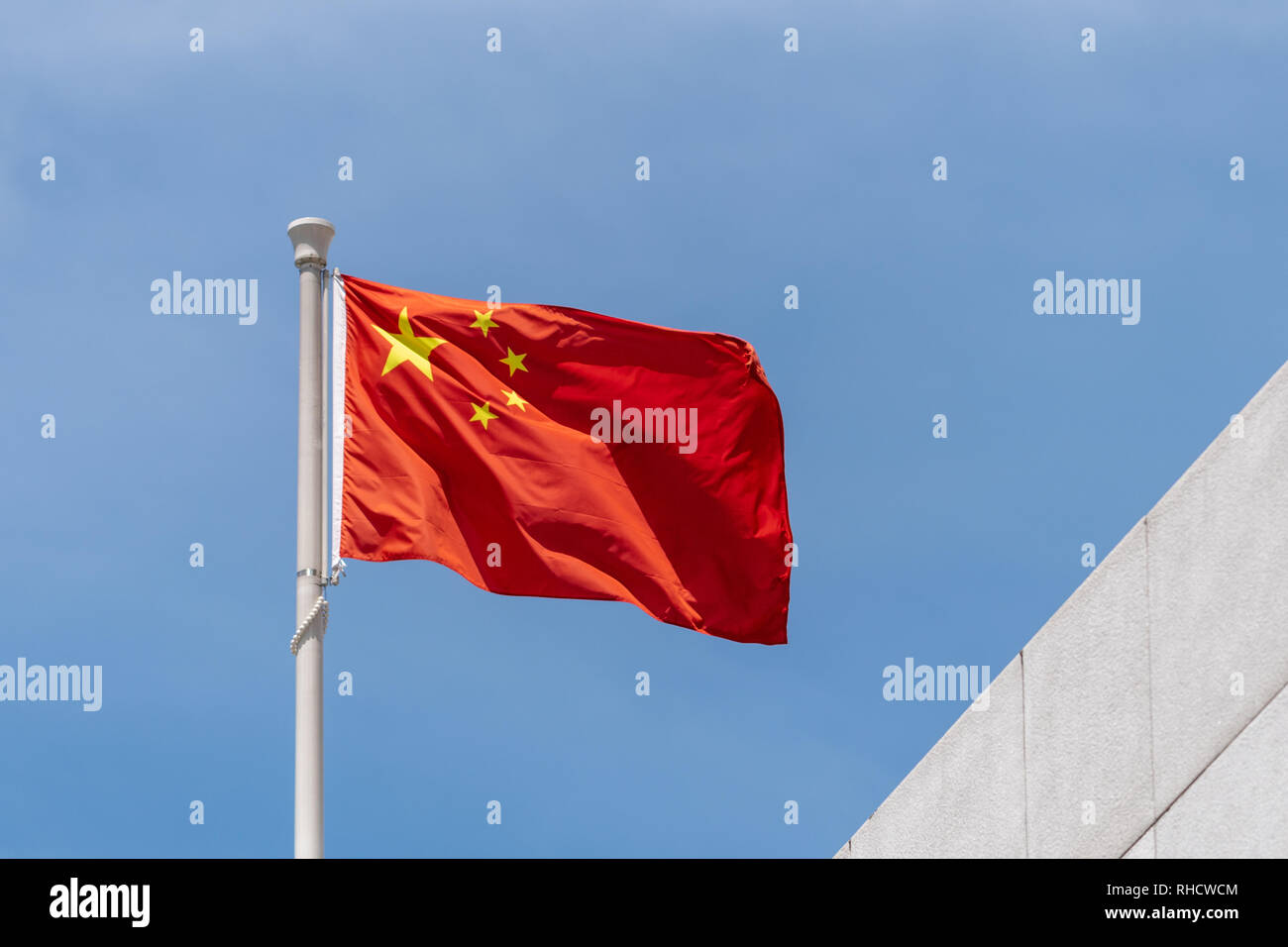 Flag of the Peoples Republic of China flying from a pole on the top of ...