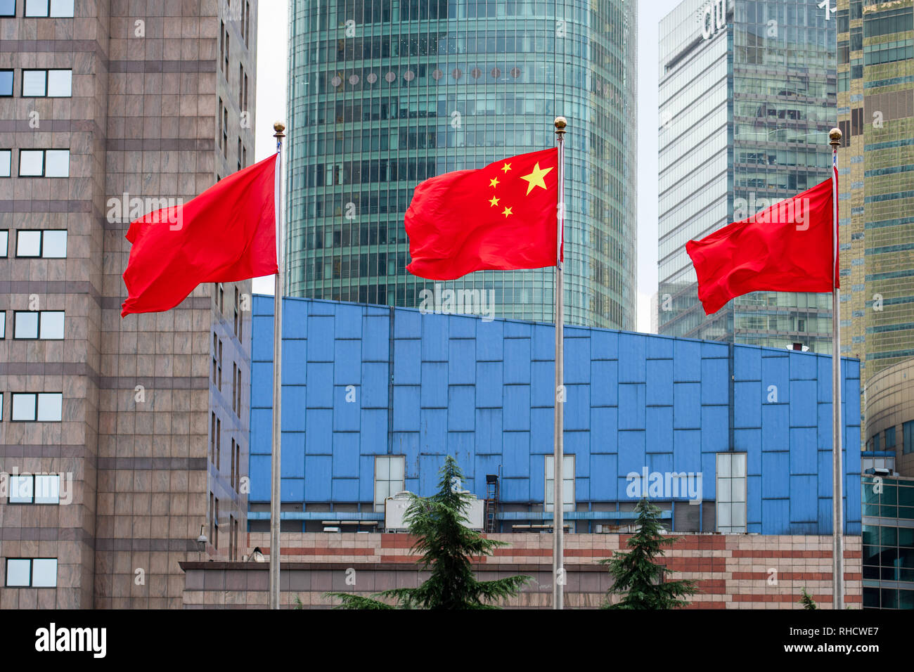 Chinese national flag flying between two red flags in pudong, Shanghai ...