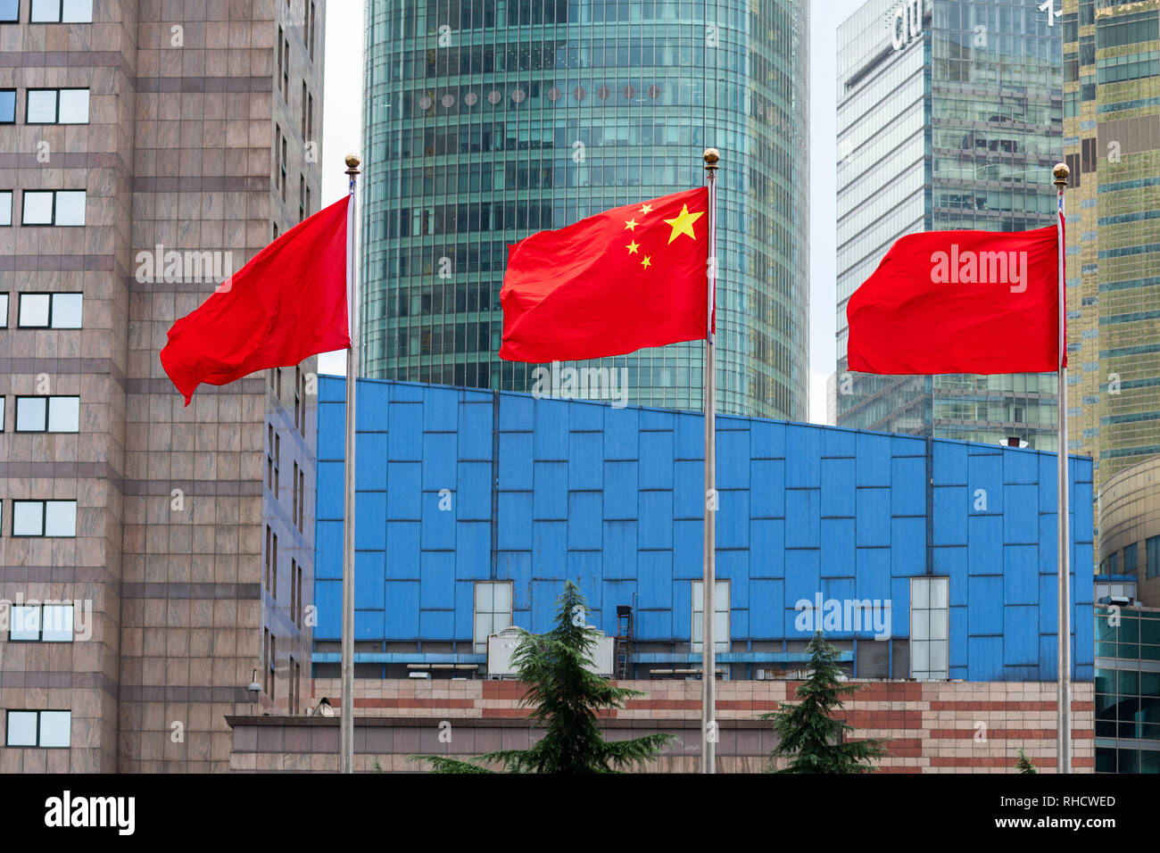 Chinese national flag flying between two red flags in pudong, Shanghai ...
