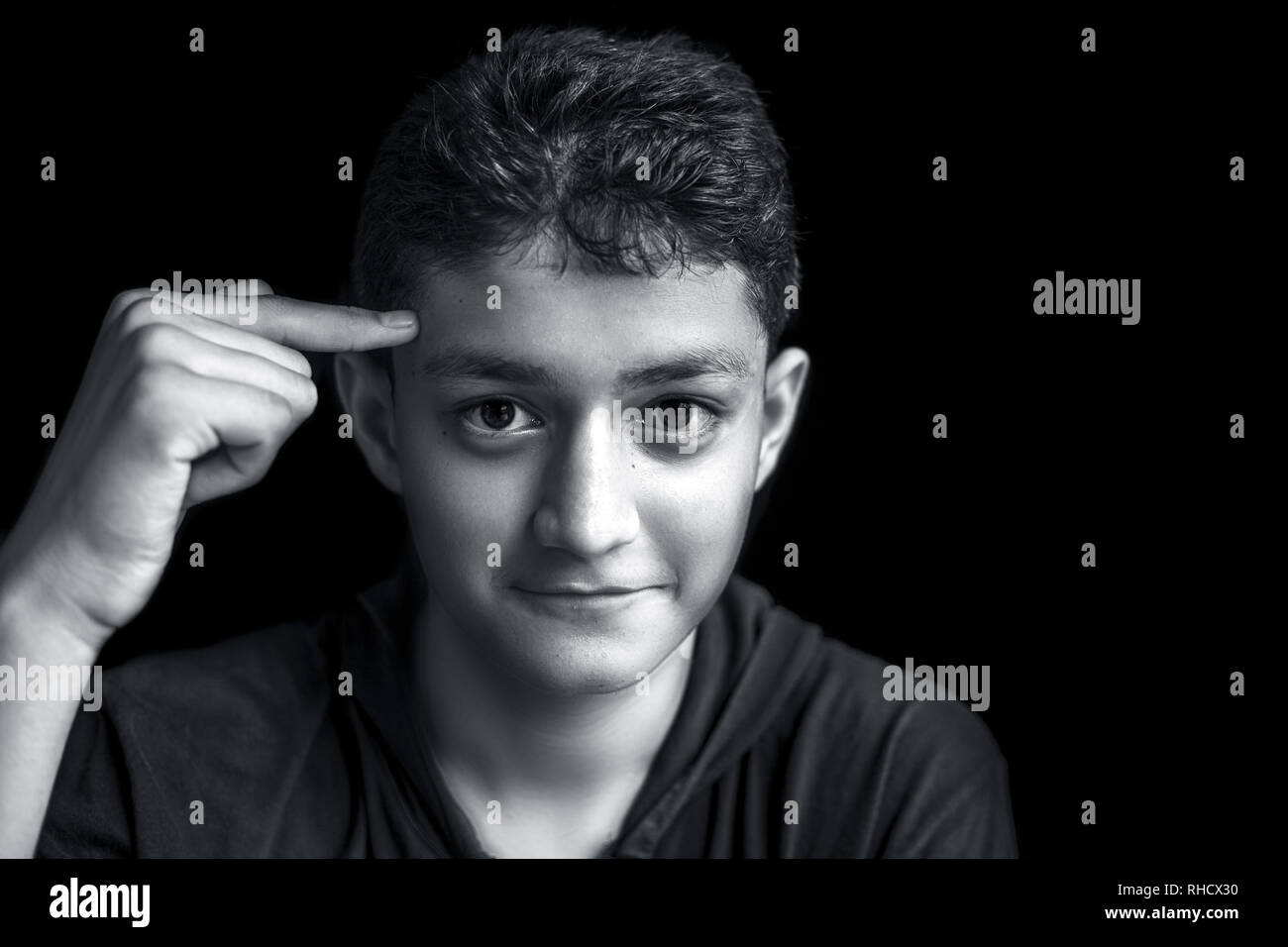Close up of boy giving or posing in facial expressions pointing his ...