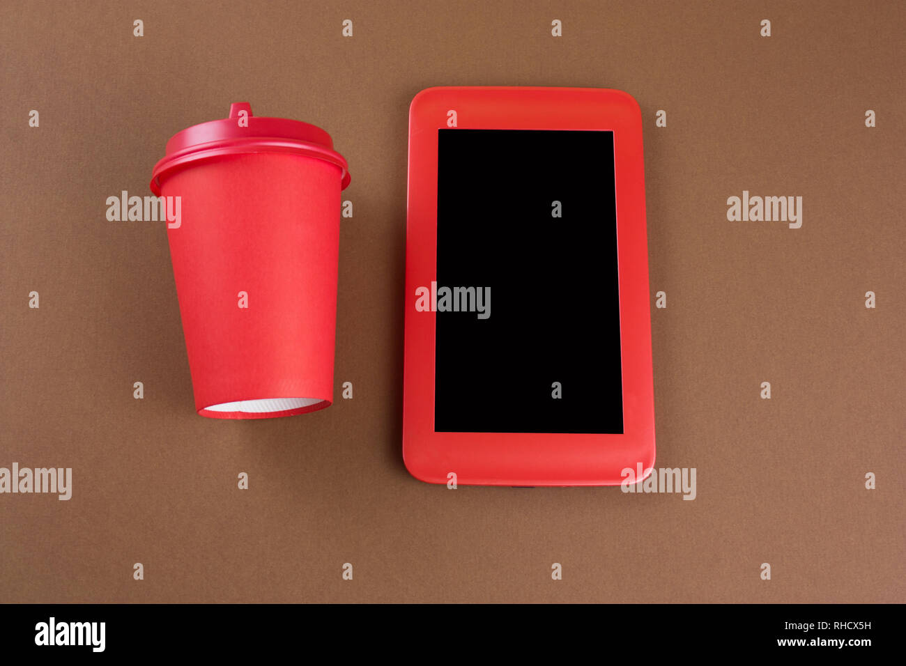 top view tablet and take away drink cup on brown background Stock Photo ...