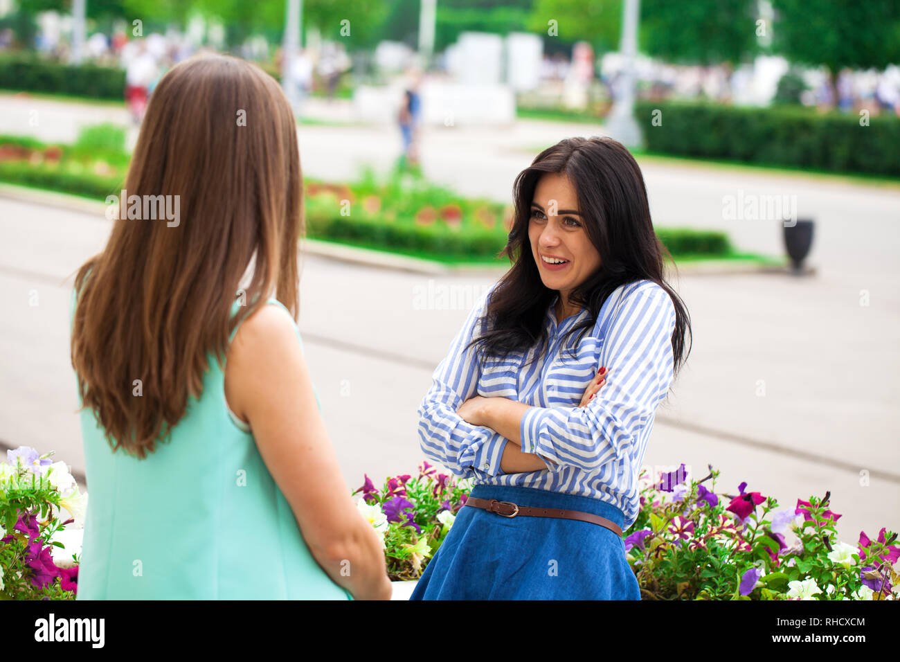 Two young women talking to each other. Girl friends having a chat Stock ...