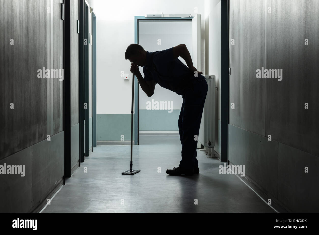 Full Length Of Man Suffering From Back Ache While Cleaning Floor Stock ...