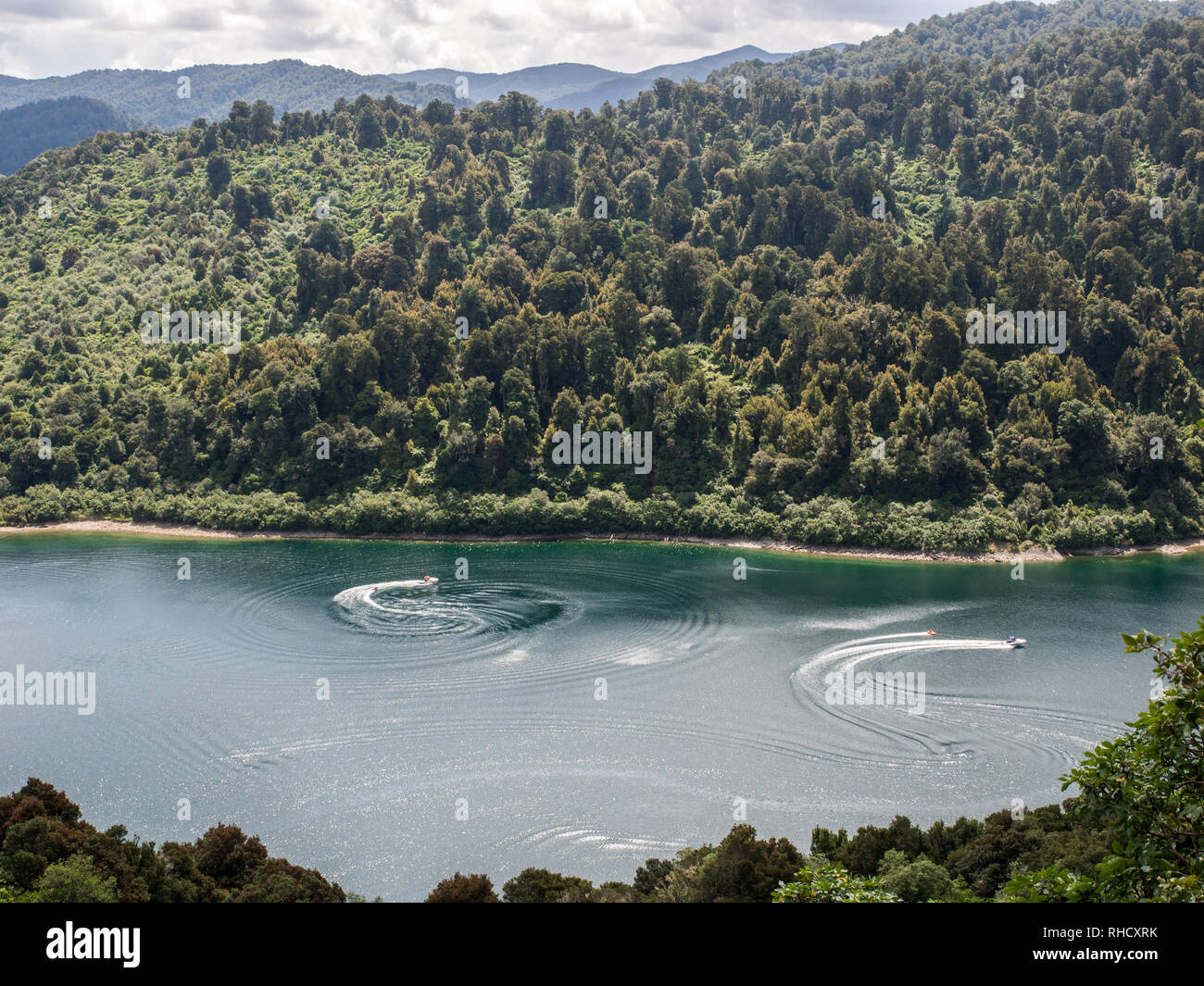 Family fun, Two motor boats with tow rafts with kids, white foam wake ...