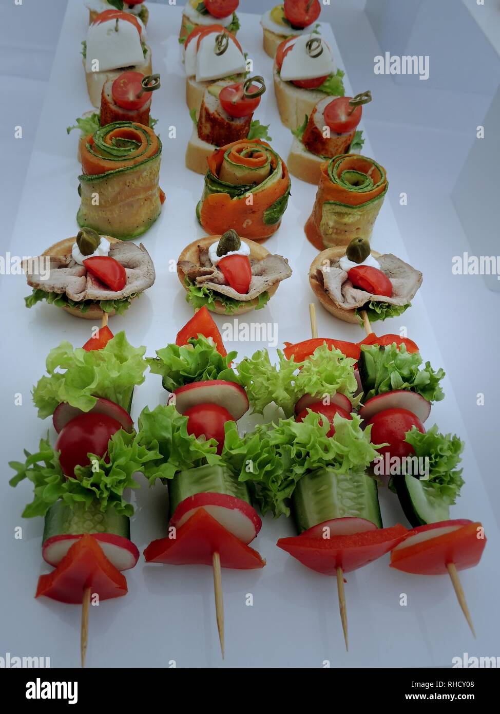 Set of appetizer table settings on the plates on white tablecloth Stock ...