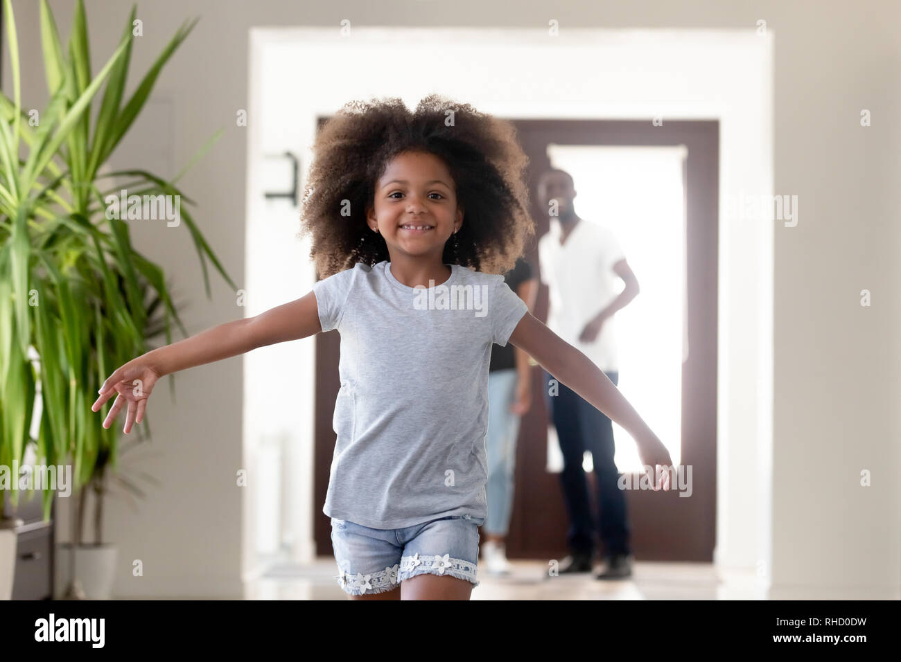 Cute african kid running in new house on moving day Stock Photo - Alamy