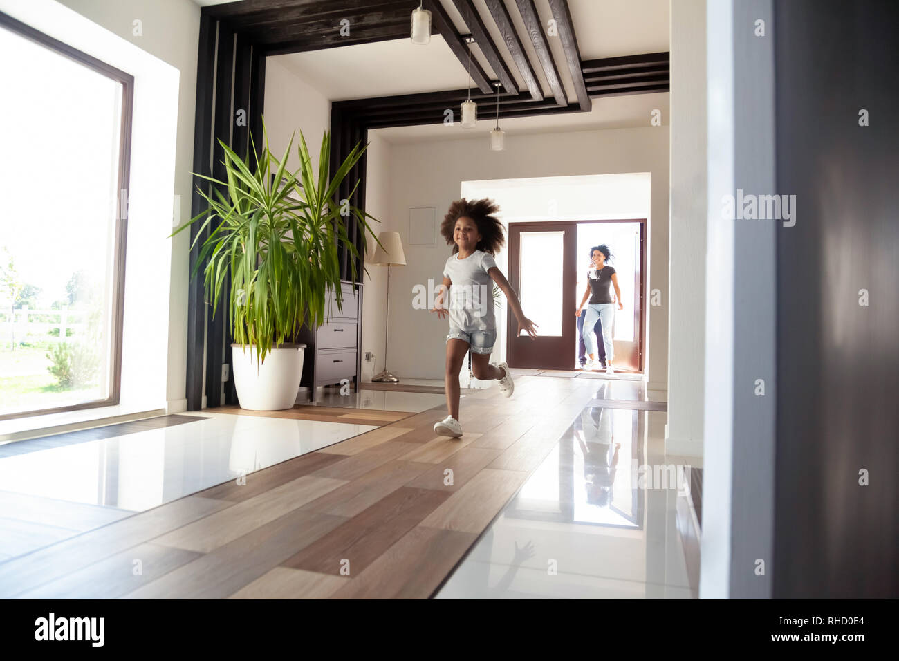 Excited american kid running in hallway entering big modern house Stock ...