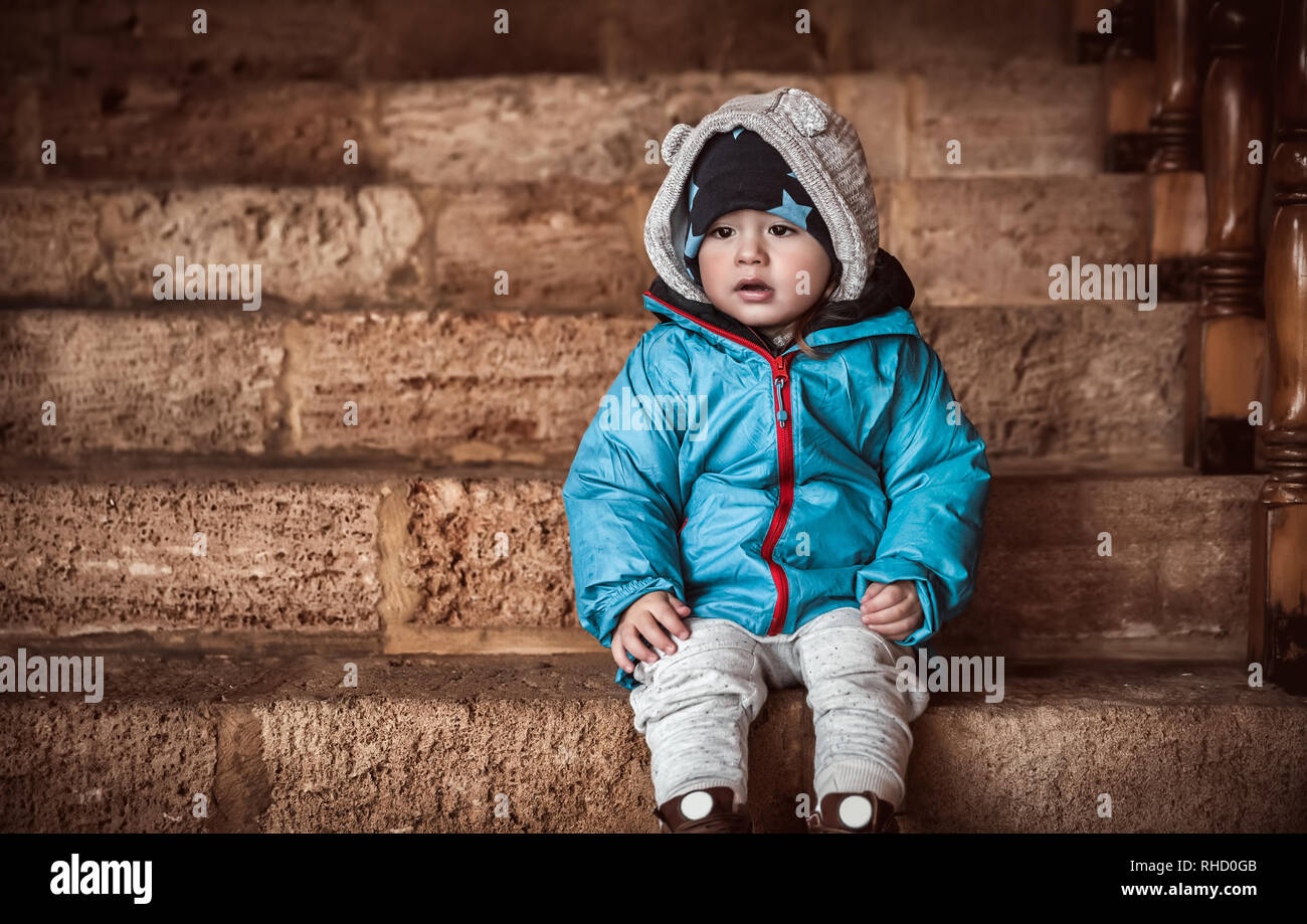 Small boy sitting on stairs hi-res stock photography and images - Alamy