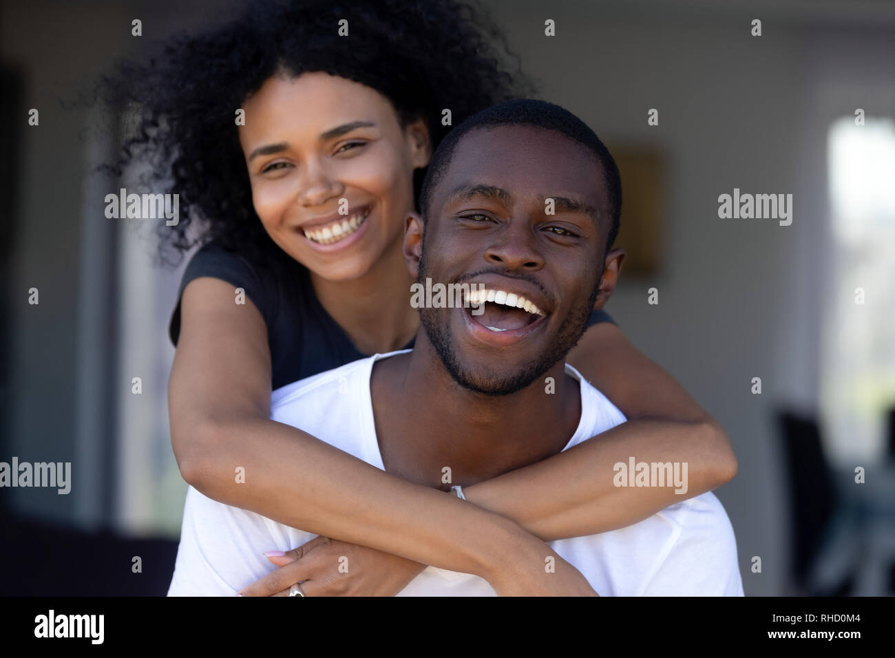 Happy millennial black couple laughing having fun outdoors, portrait ...