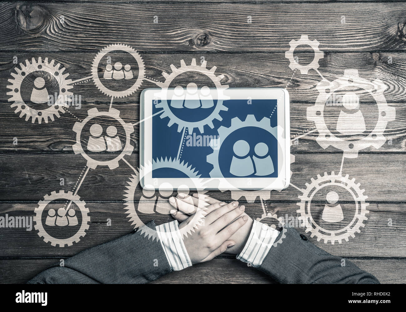 Concept of teamworking and connection with gears mechanism and tablet ...