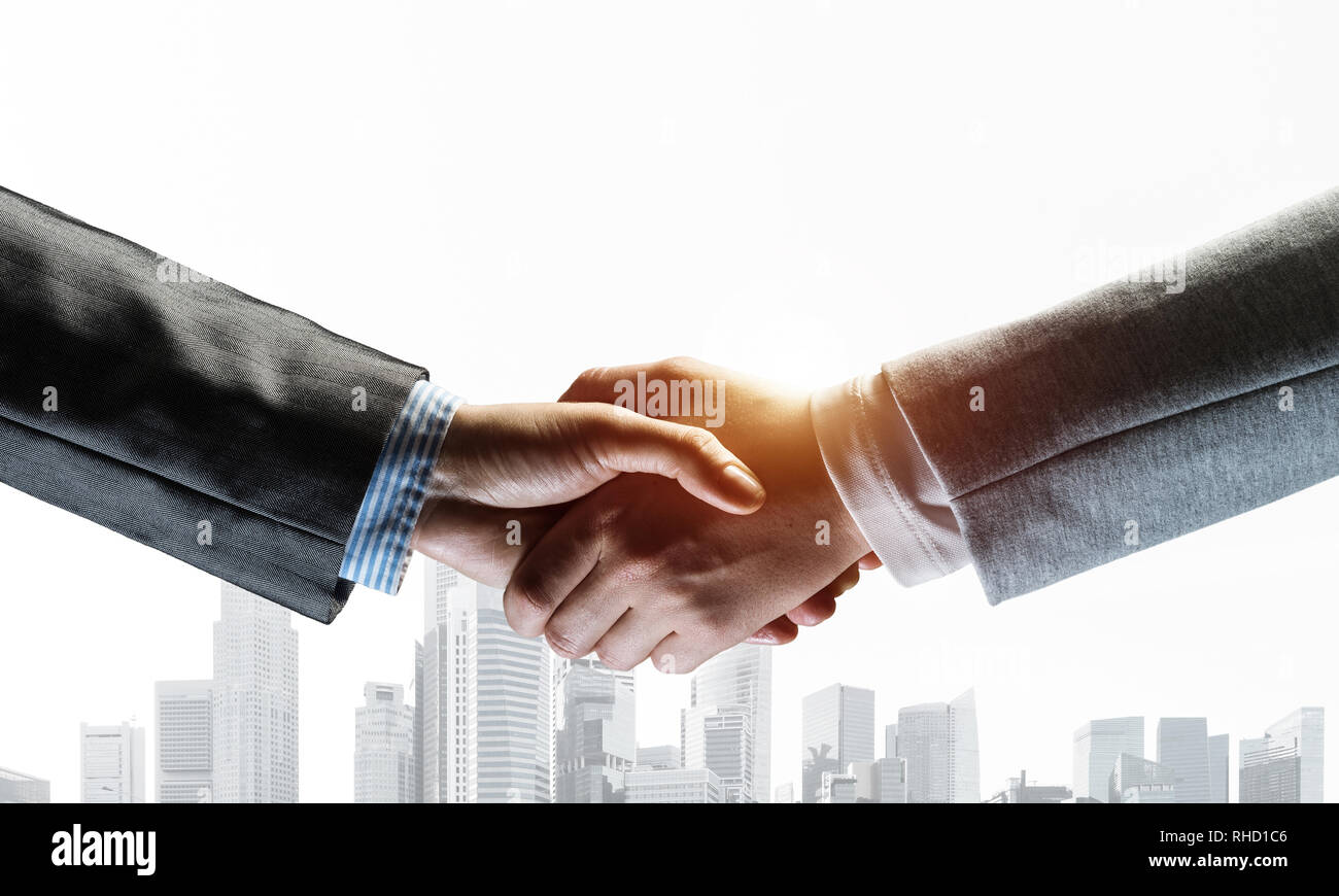Business handshake as idea for unity and cooperation or greeting. Mixed ...