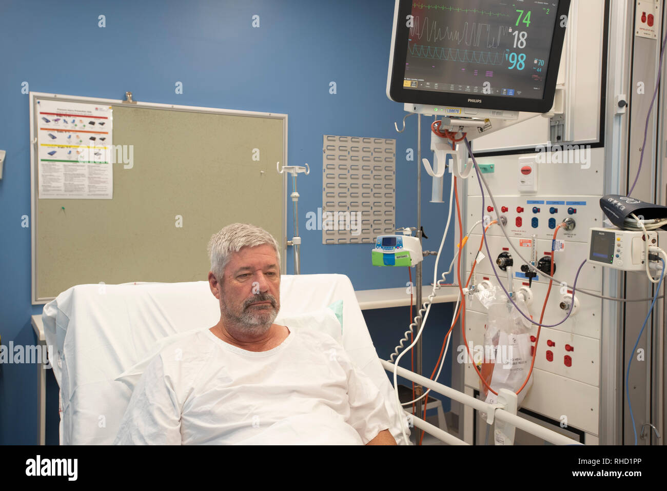 Man in hospital with family around him Stock Photo - Alamy