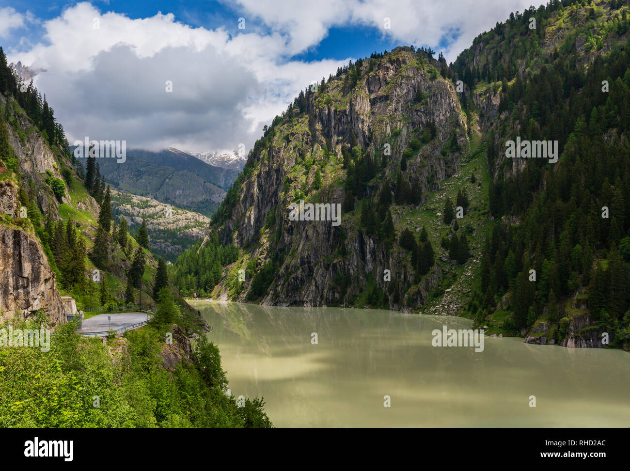 Summer Alps mountain landscape with turbid water reservoir lake and ...