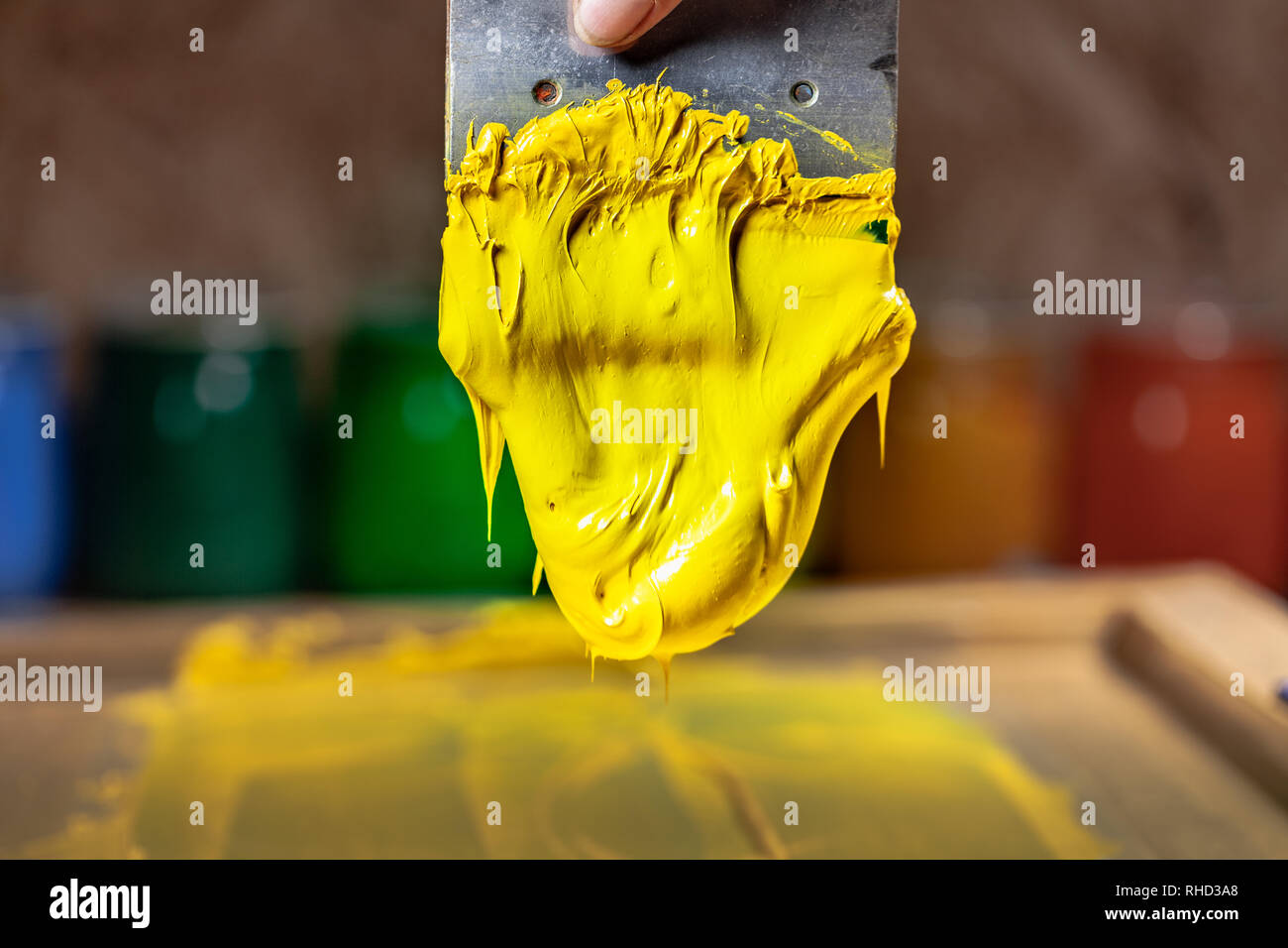 yellow color dripping from hand screen printing during printing tee ...
