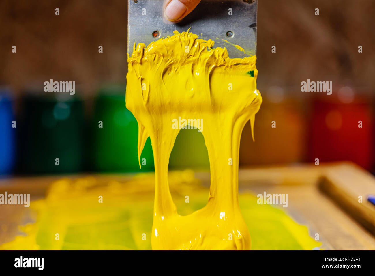 yellow color dripping from hand screen printing during printing tee ...