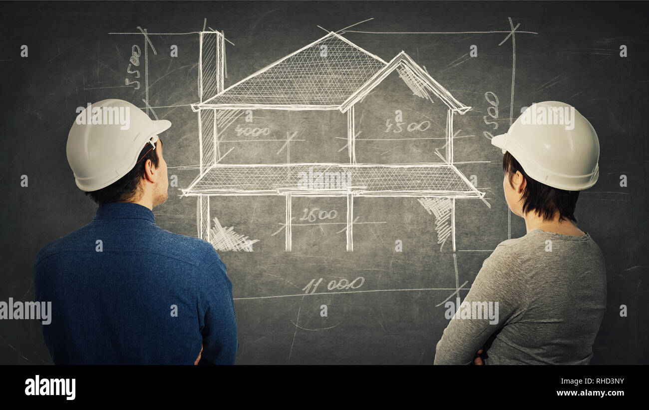 Construction engineers man and woman wearing protective helmet sharing ...