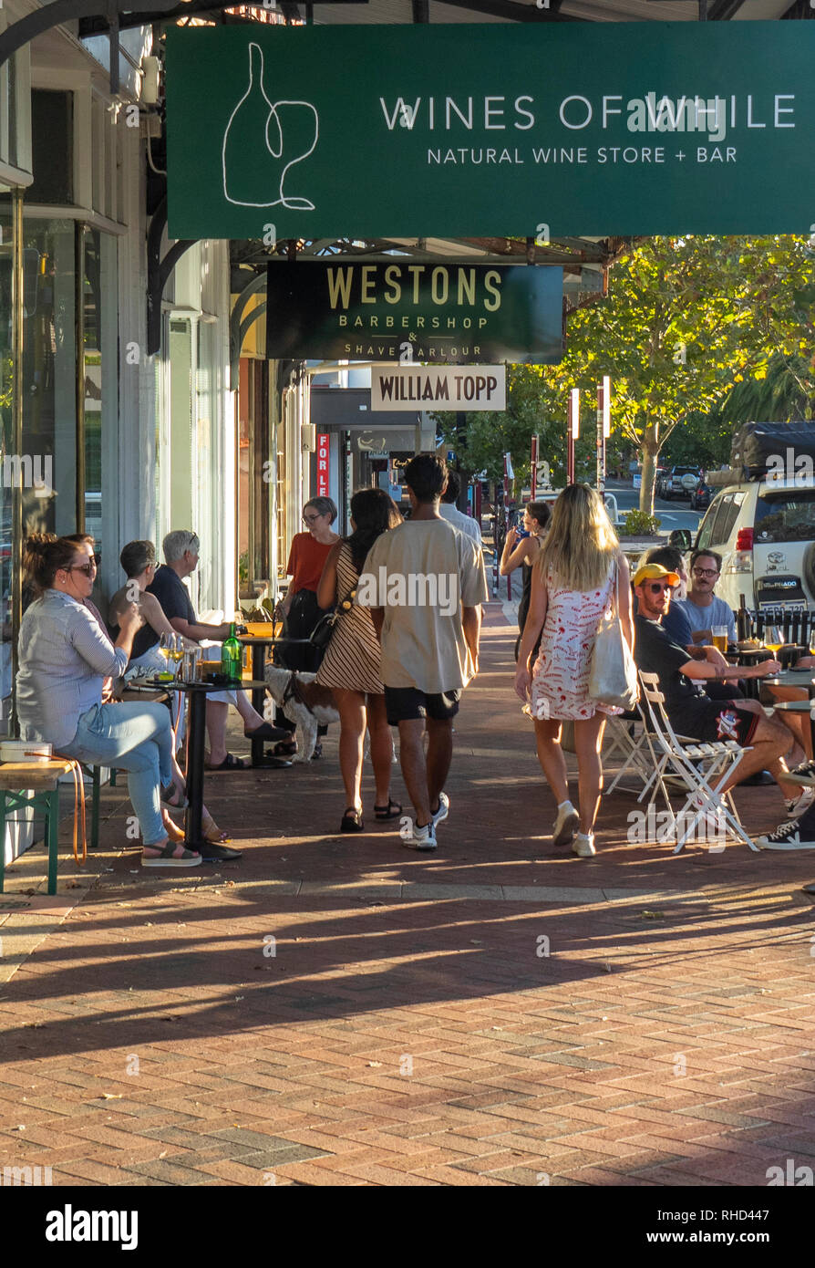 People sitting outdoors on the pavement al fresco outside Wines of ...