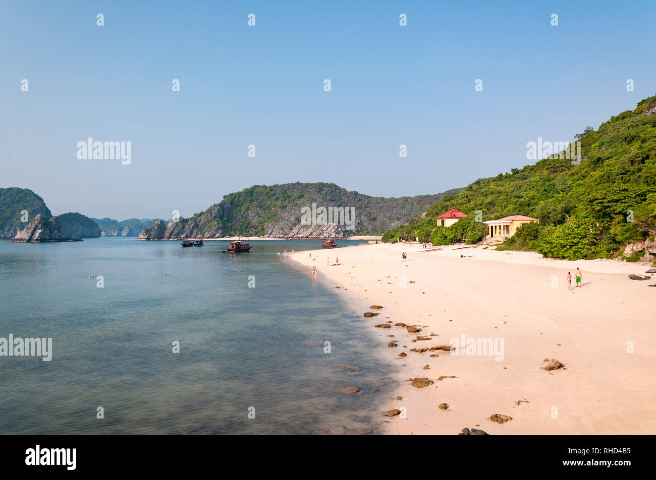 A large limestone island with sandy beach and thick vegetation with ...