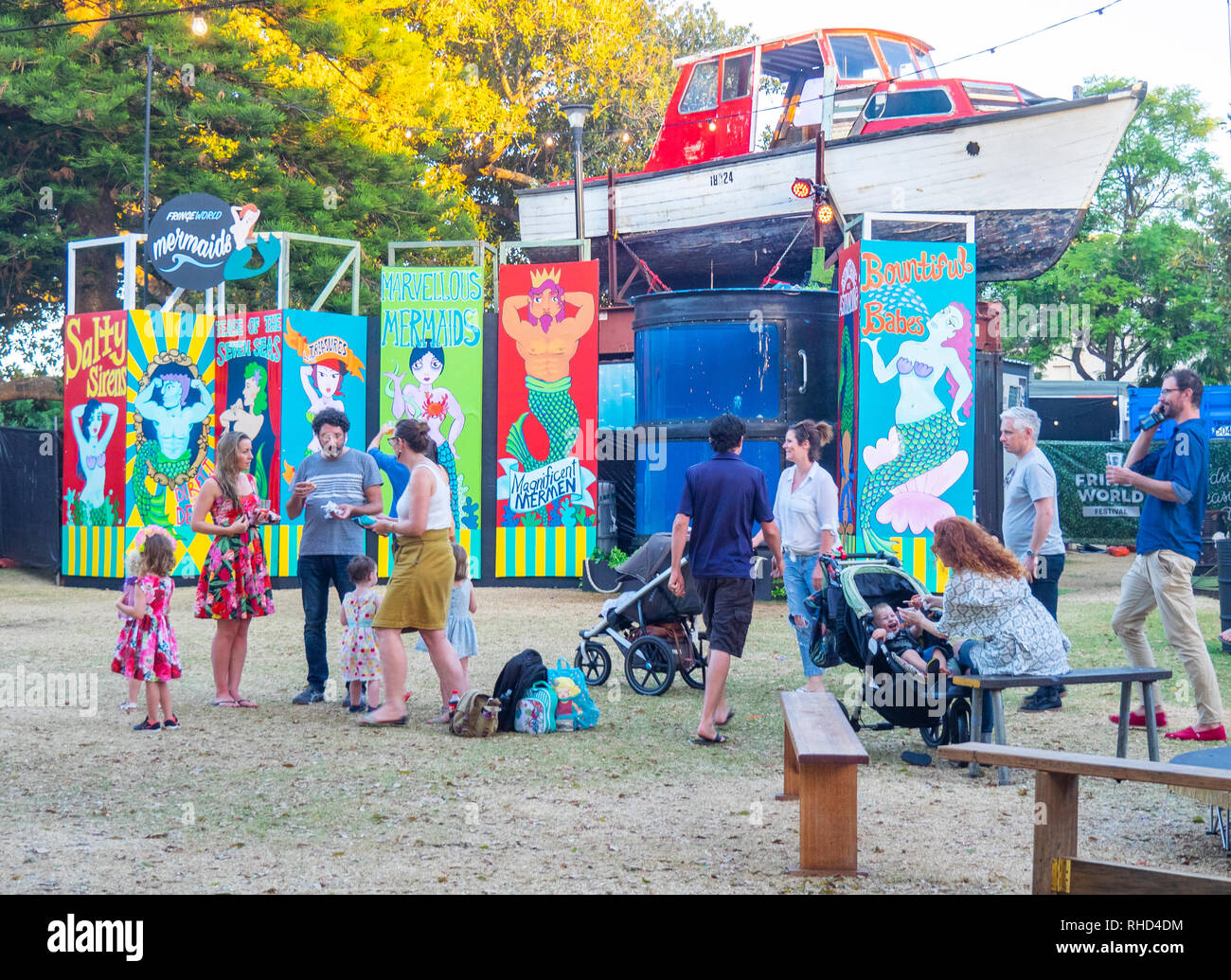 People standing in front of pop up venue for mermaid and merman show at ...