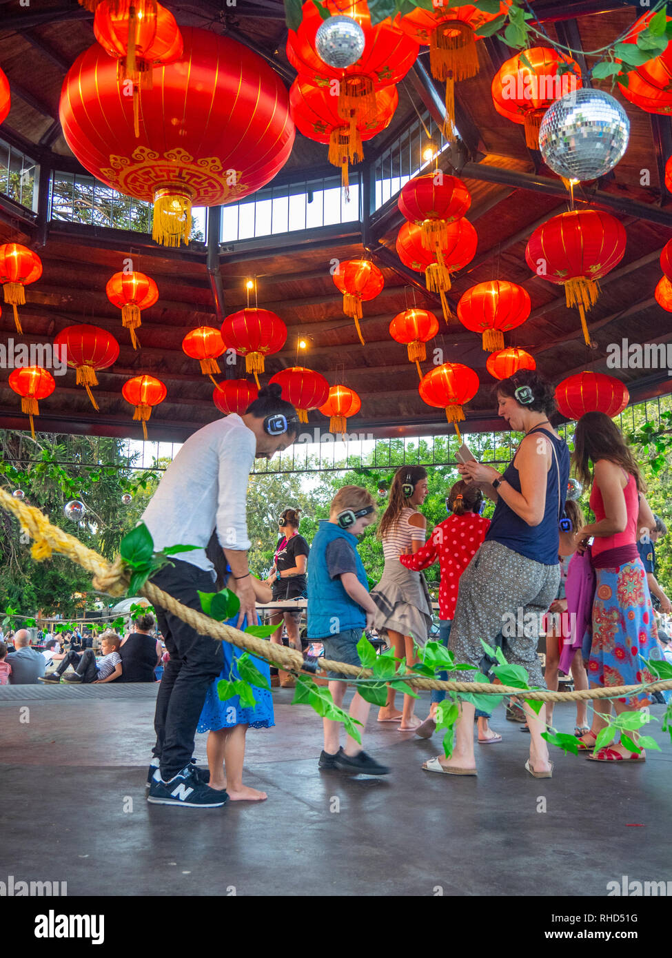 Children dancing in a silent disco while their parents watch in the ...