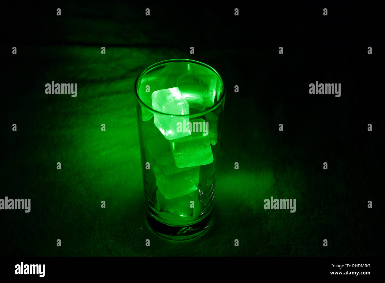 Ice cubes in a glass scattering light from a green laser pointer Stock ...