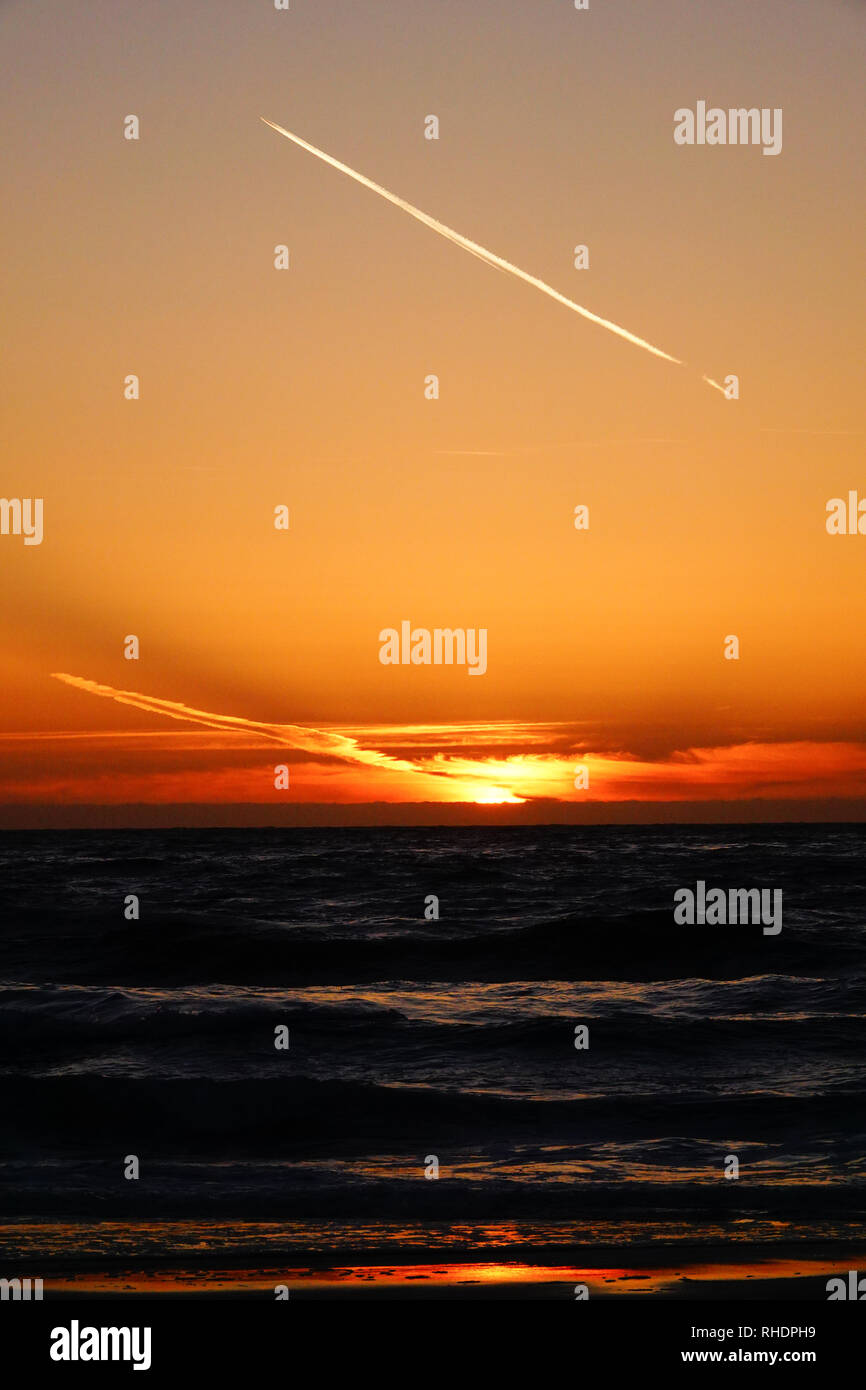 The sun sets to the west while sharing its sunset color upon the ...