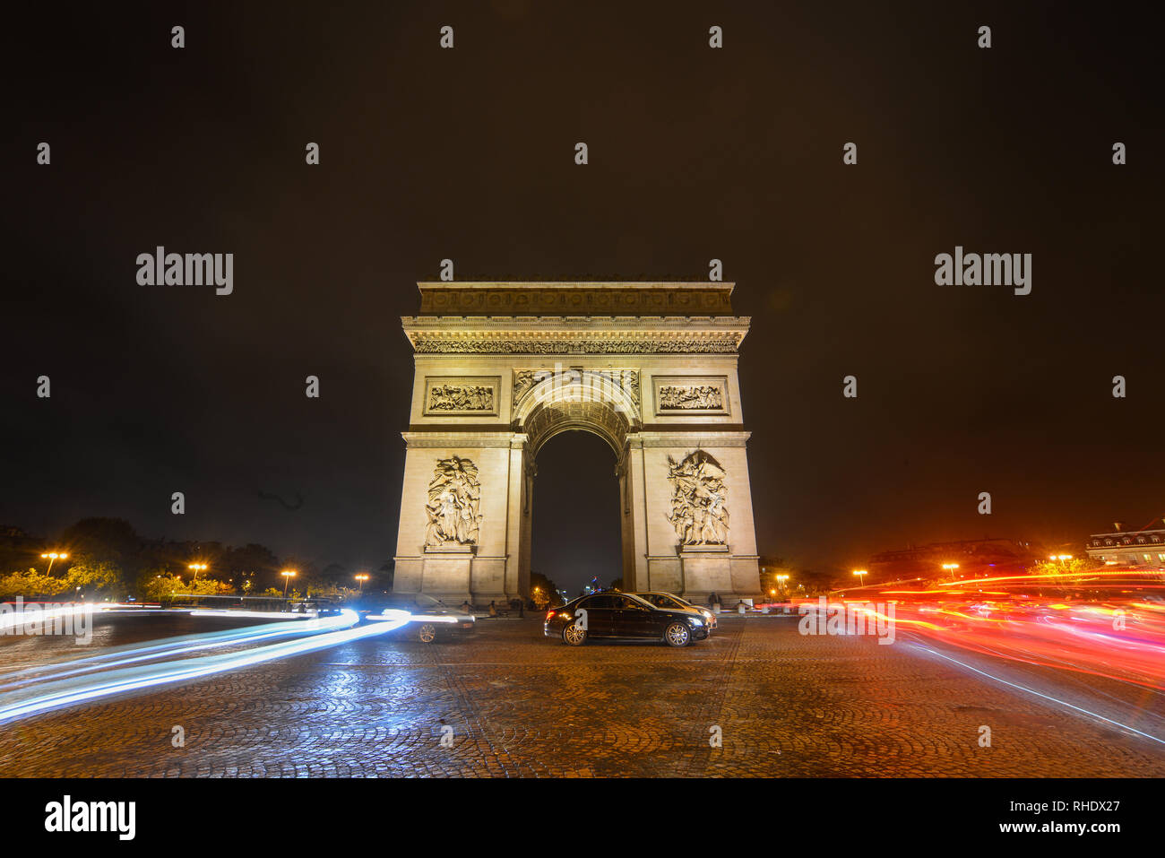 The Triumphal Arch at evening in Paris, France. Arc de Triomphe was ...