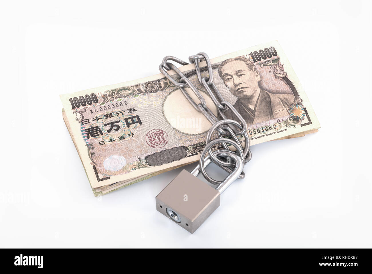 Yen bank notes with a lock and chain. Money stack for safety and ...