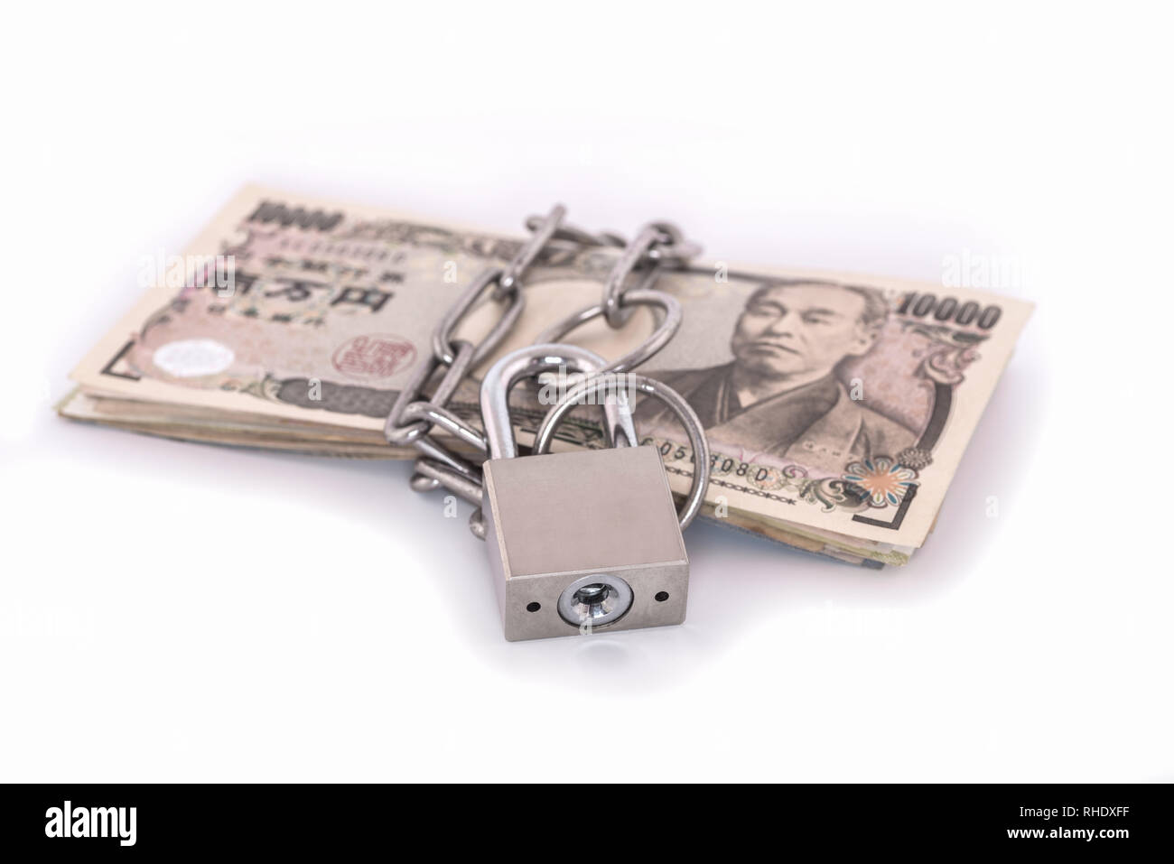 Yen bank notes with a lock and chain. Money stack for safety and ...