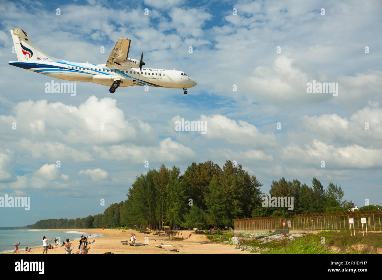 Plane over the beach Stock Photo - Alamy