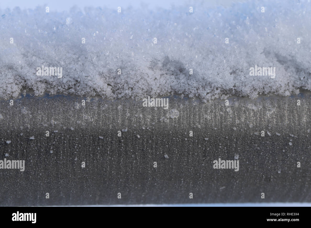 A closeup of a frozen silver colored metal pipe. Photographed during a ...