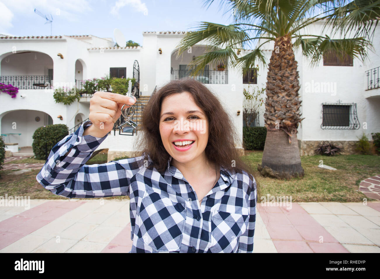 Ownership, real estate, purchase and rent concept - Woman with keys ...