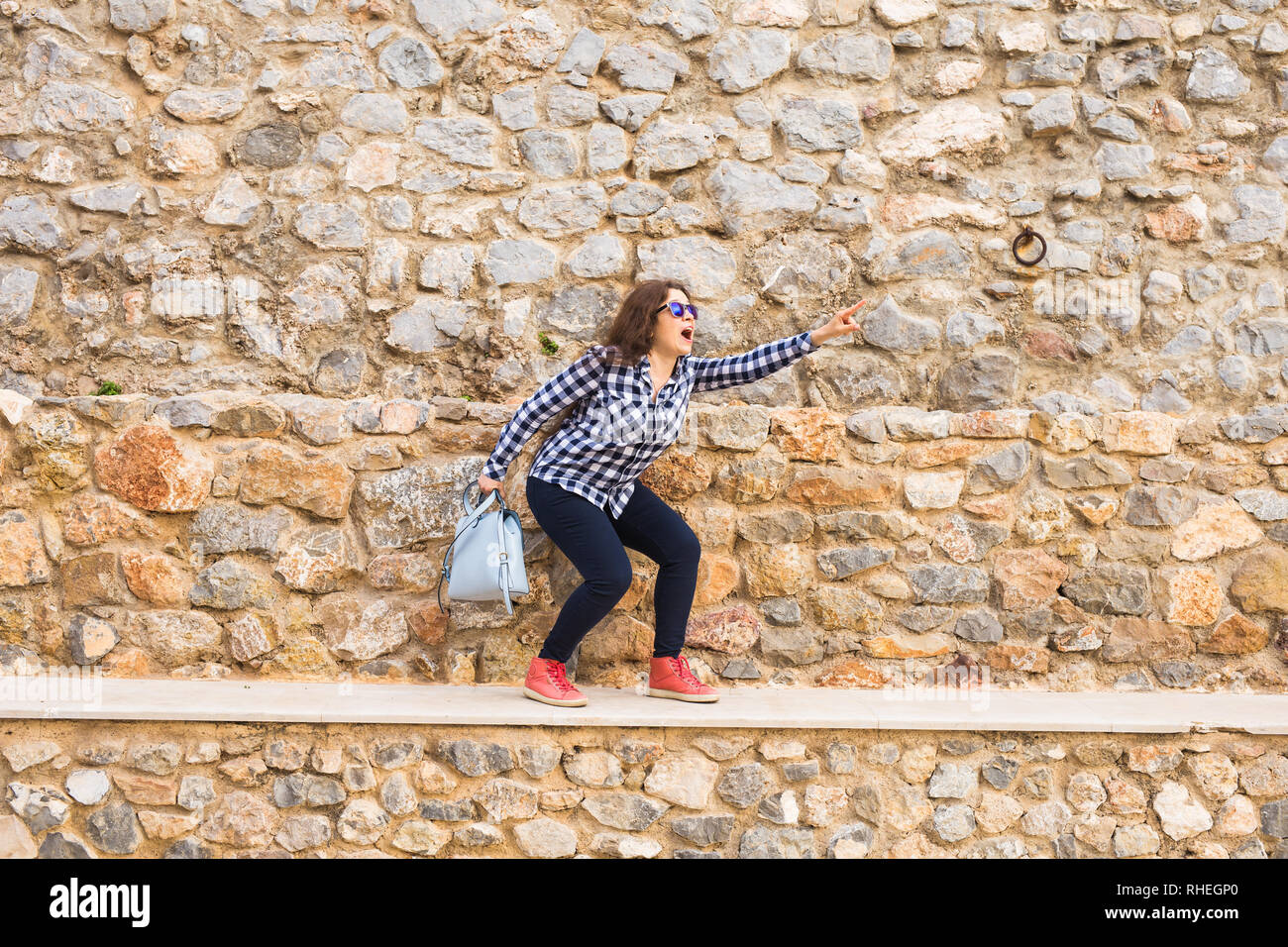 Emotions and gestures - Surprised young woman pointing something ...