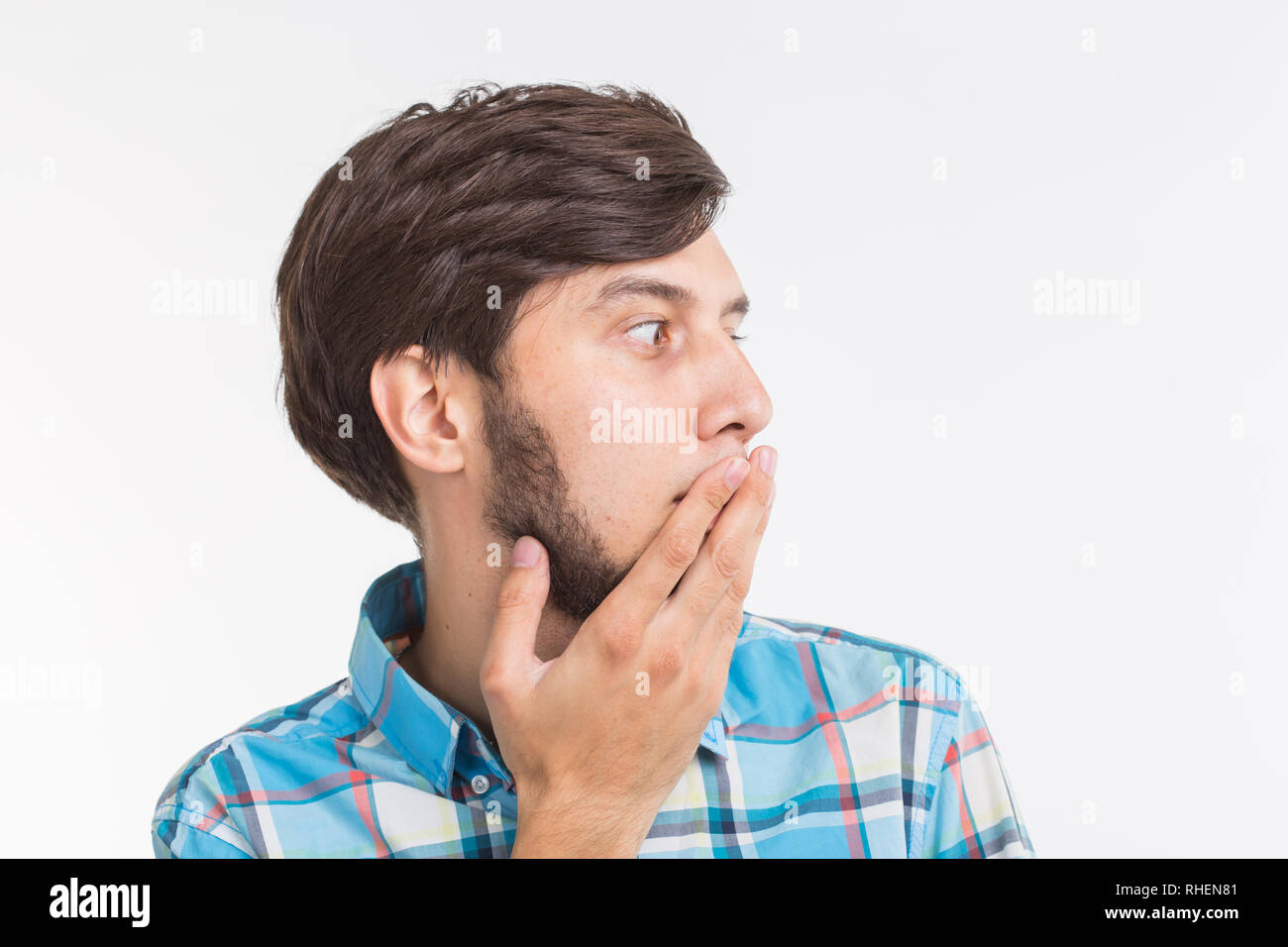 People, emotions and gesture concept - young surprised man covering his ...