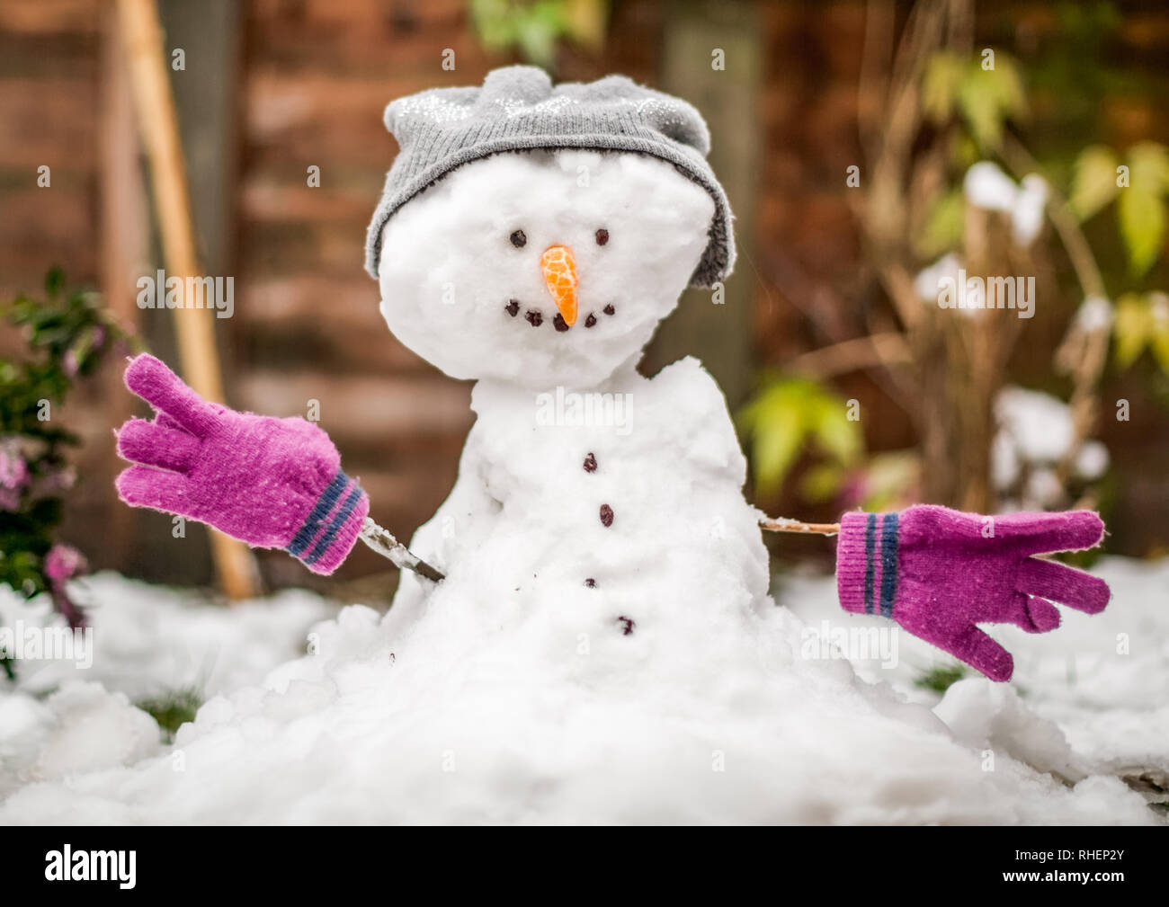 A little snowman in a garden Stock Photo - Alamy