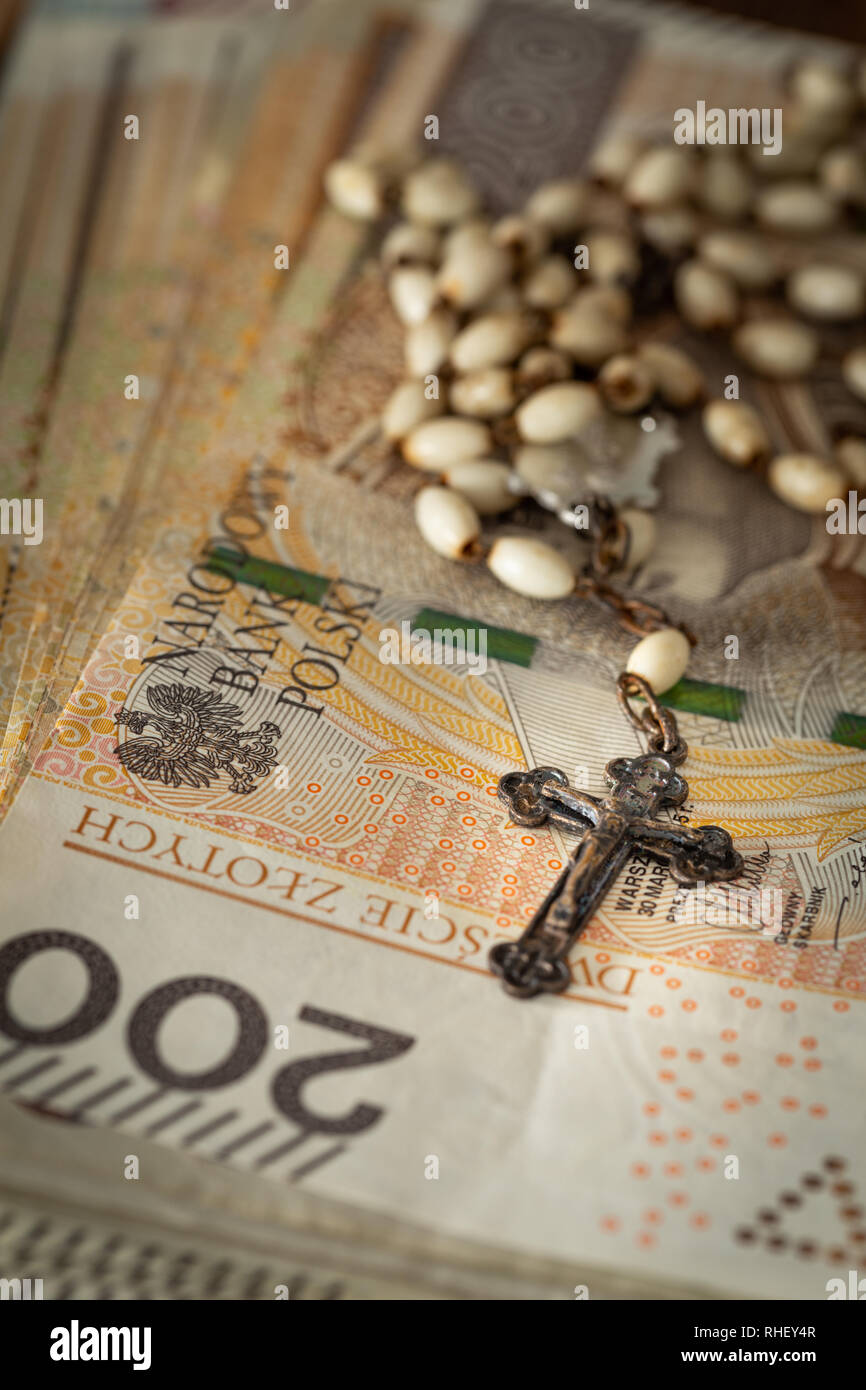 Catholic cross on a background of money / concept Stock Photo - Alamy