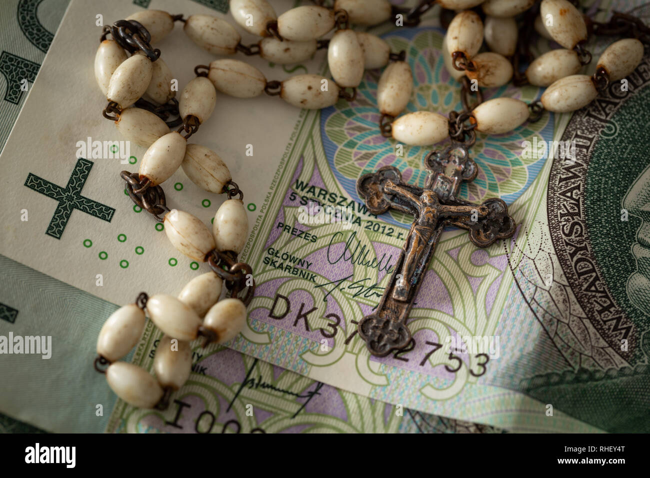 Catholic cross on a background of money / concept Stock Photo - Alamy
