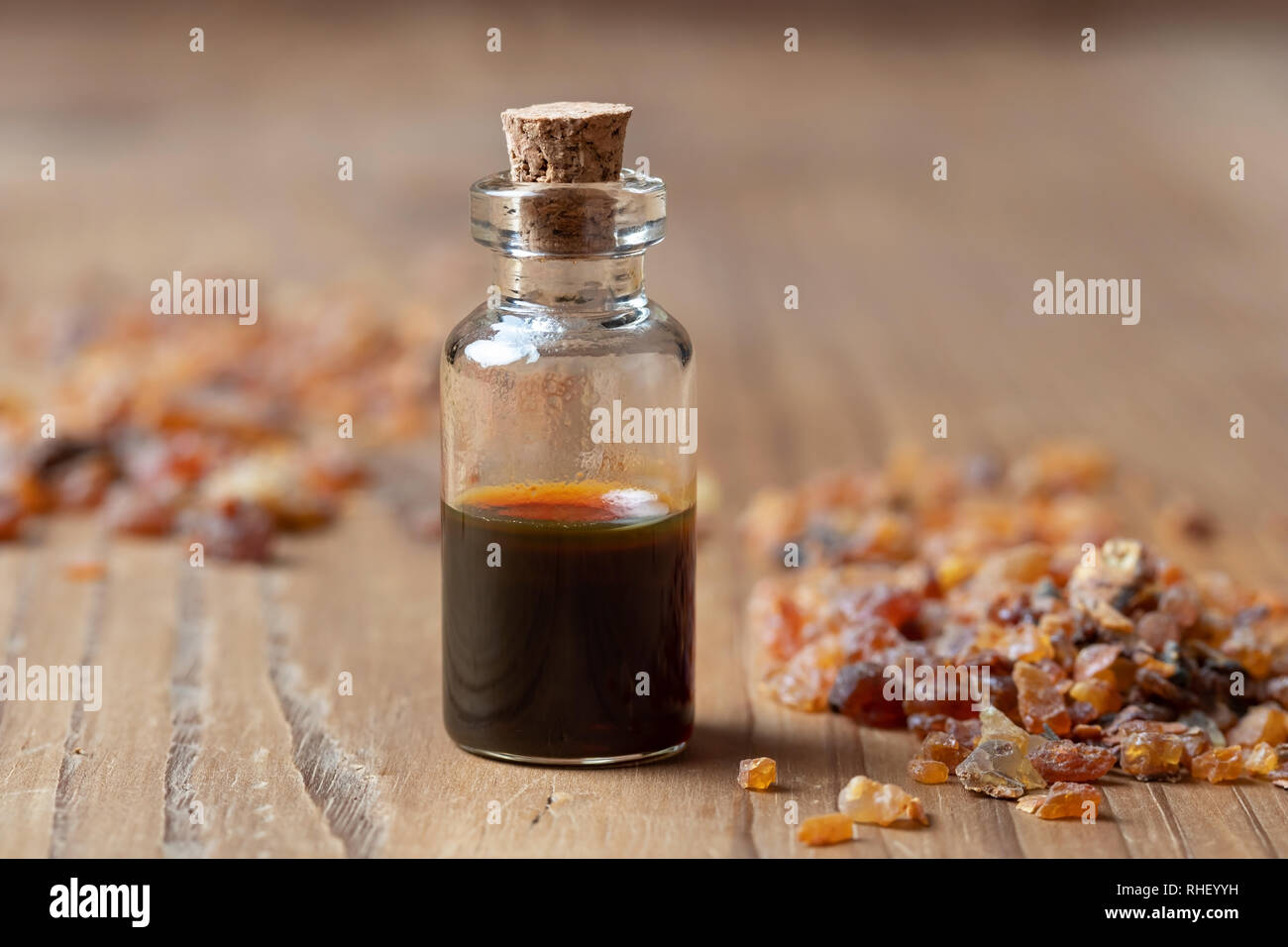 A bottle of essential oil with myrrh resin crystals Stock Photo - Alamy